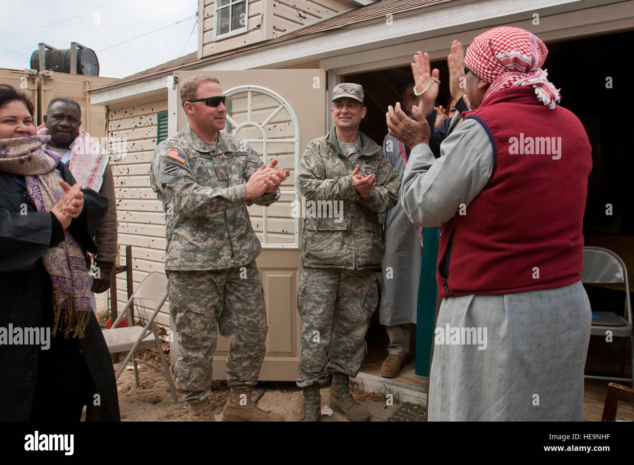 Role-playing actors give Col. Warren Hurst (center), commander of the ...