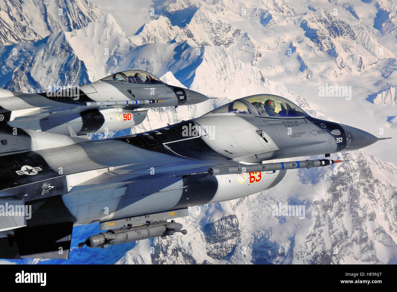 A pair of F-16 Fighting Falcon Aggressors fly over the Alaska Range ...