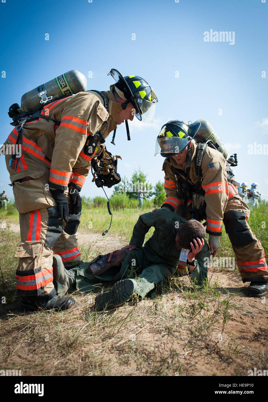 Eglin Air Force Base firefighters prepare to move a simulated victim ...
