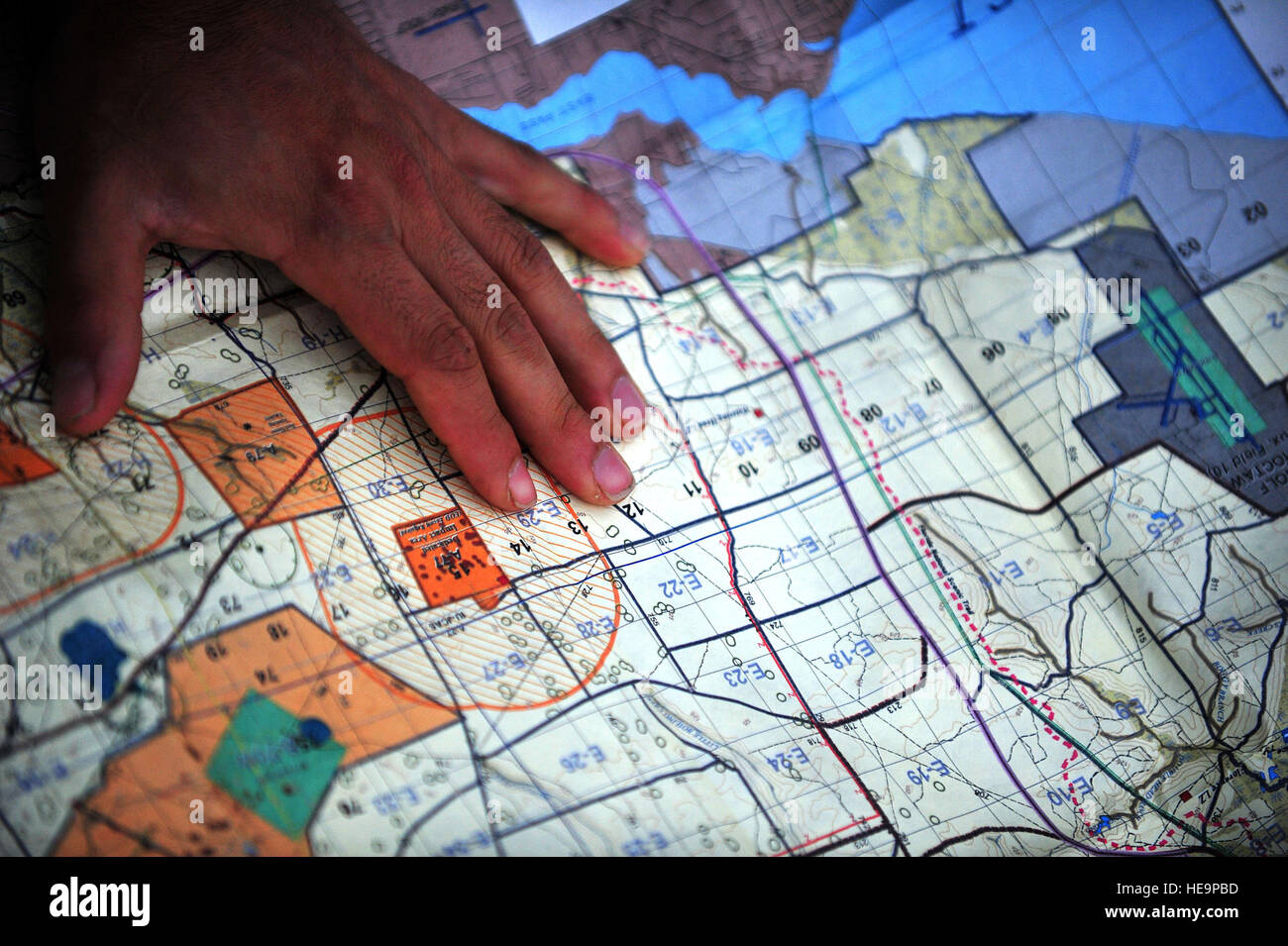 A U.S. Army Special Forces member reviews a map during Emerald Warrior ...