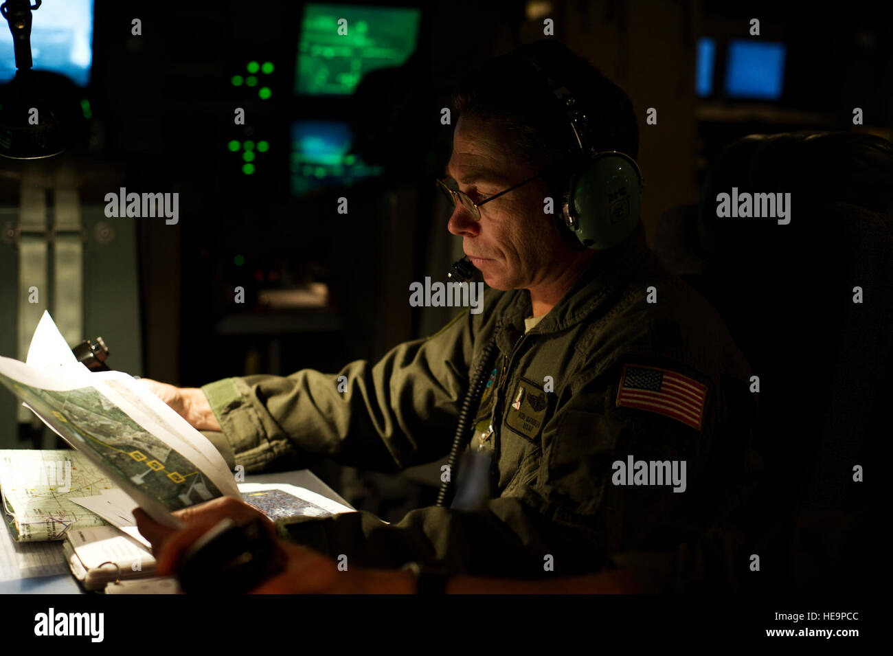 A U.S. Air Force member reviews a map before a simulation flight at ...