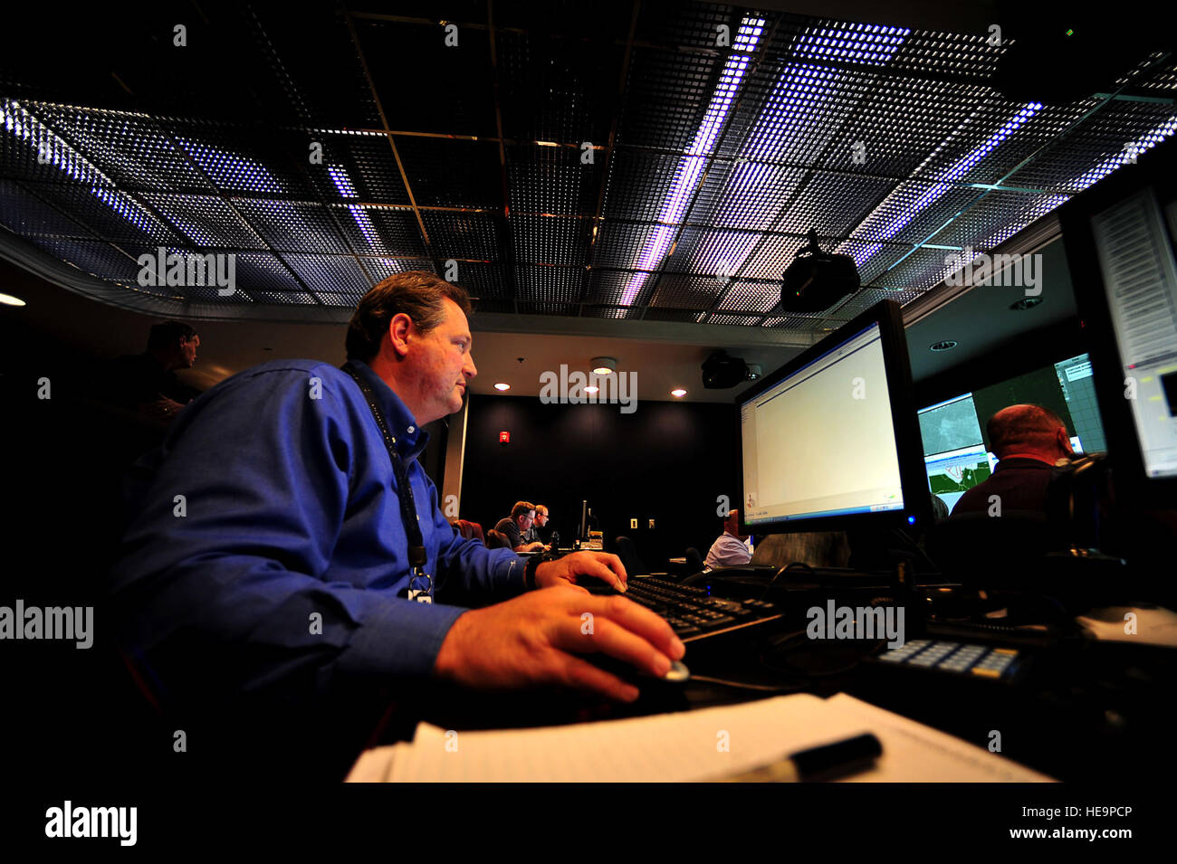 A Lockheed Martin Corp. civilian administers and observes a simulator ...