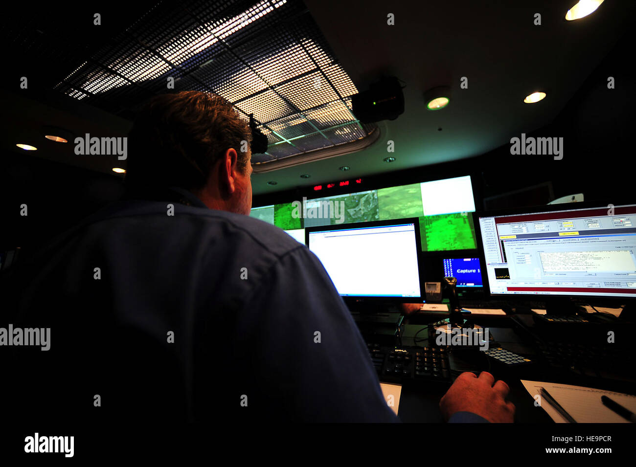 A Lockheed Martin Corp. civilian administers and observes a simulator ...
