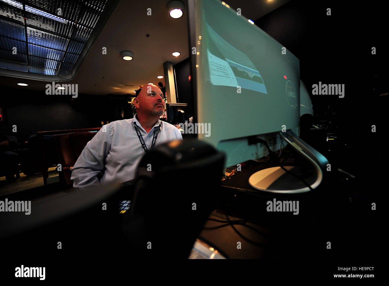 A Lockheed Martin Corp. civilian administers and observes a simulator ...