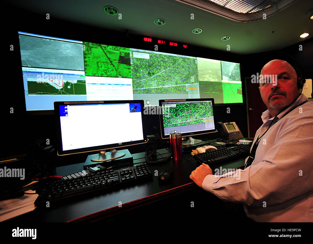 A Lockheed Martin Corp. civilian administers and observes a simulator ...