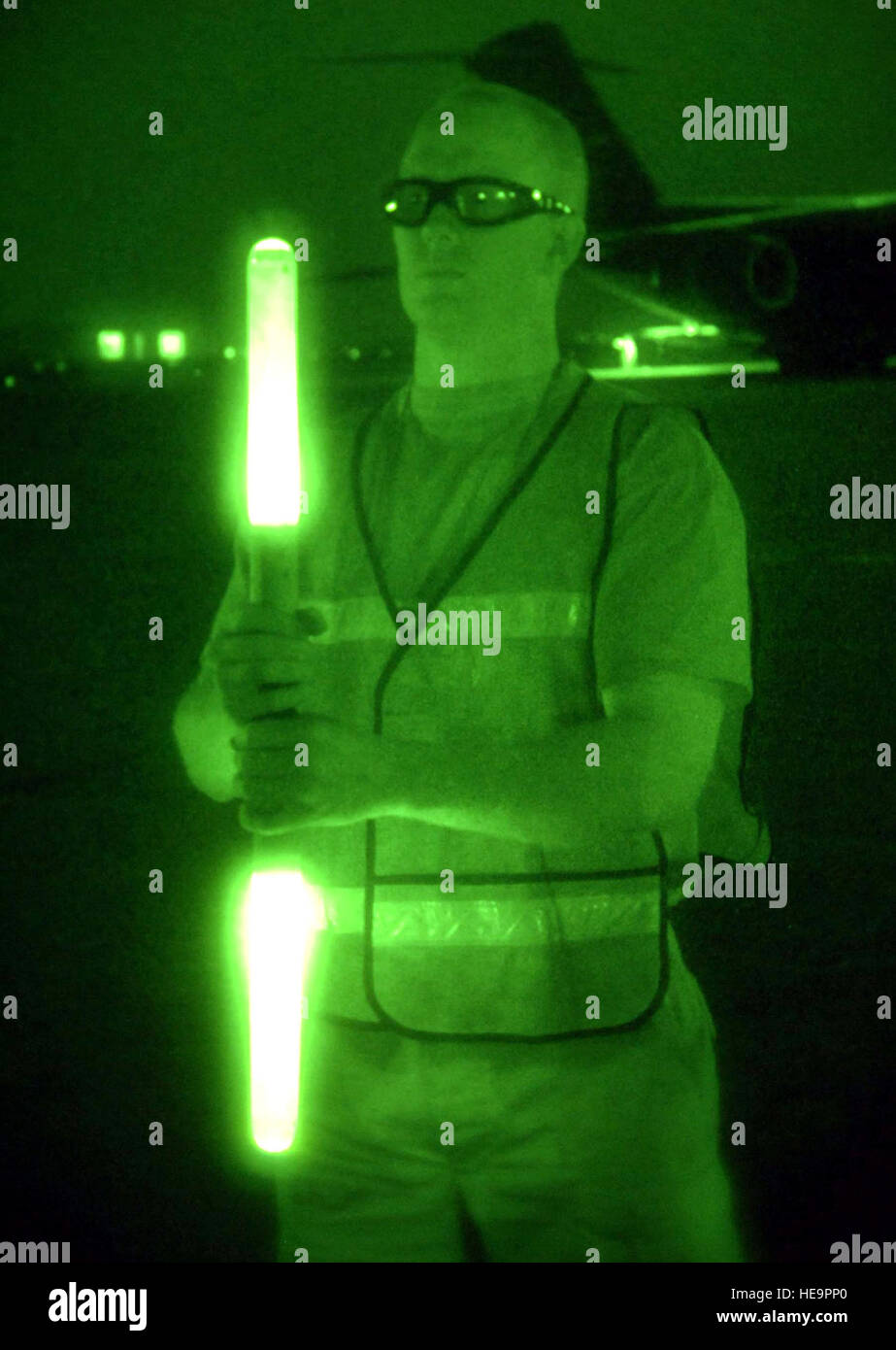 Staff Sgt. Jacob Whetstone holds a pair of marshalling sticks to signal ...