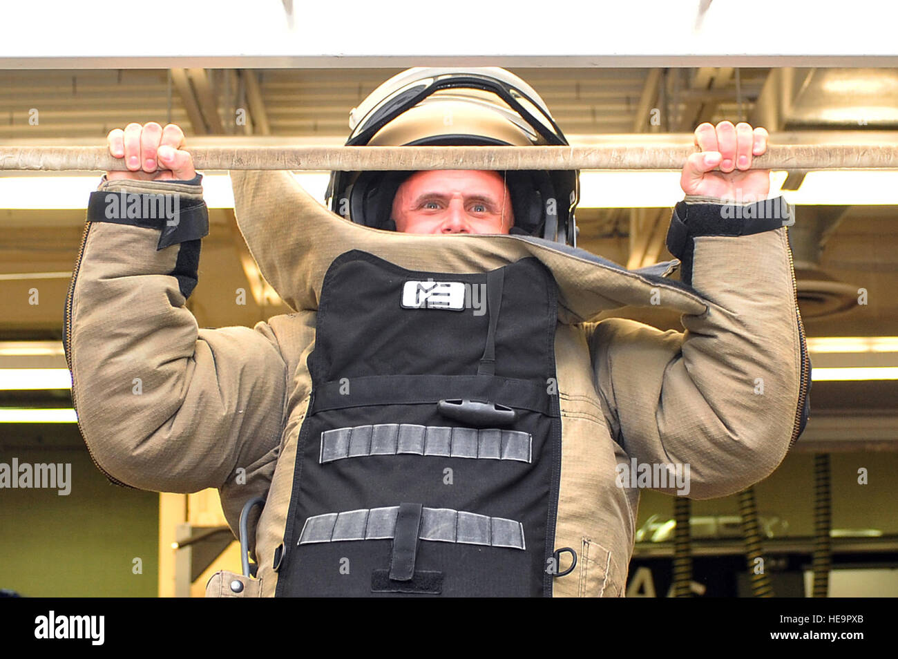A law enforcement deputy performs pull-ups while wearing a Med-Eng EOD ...