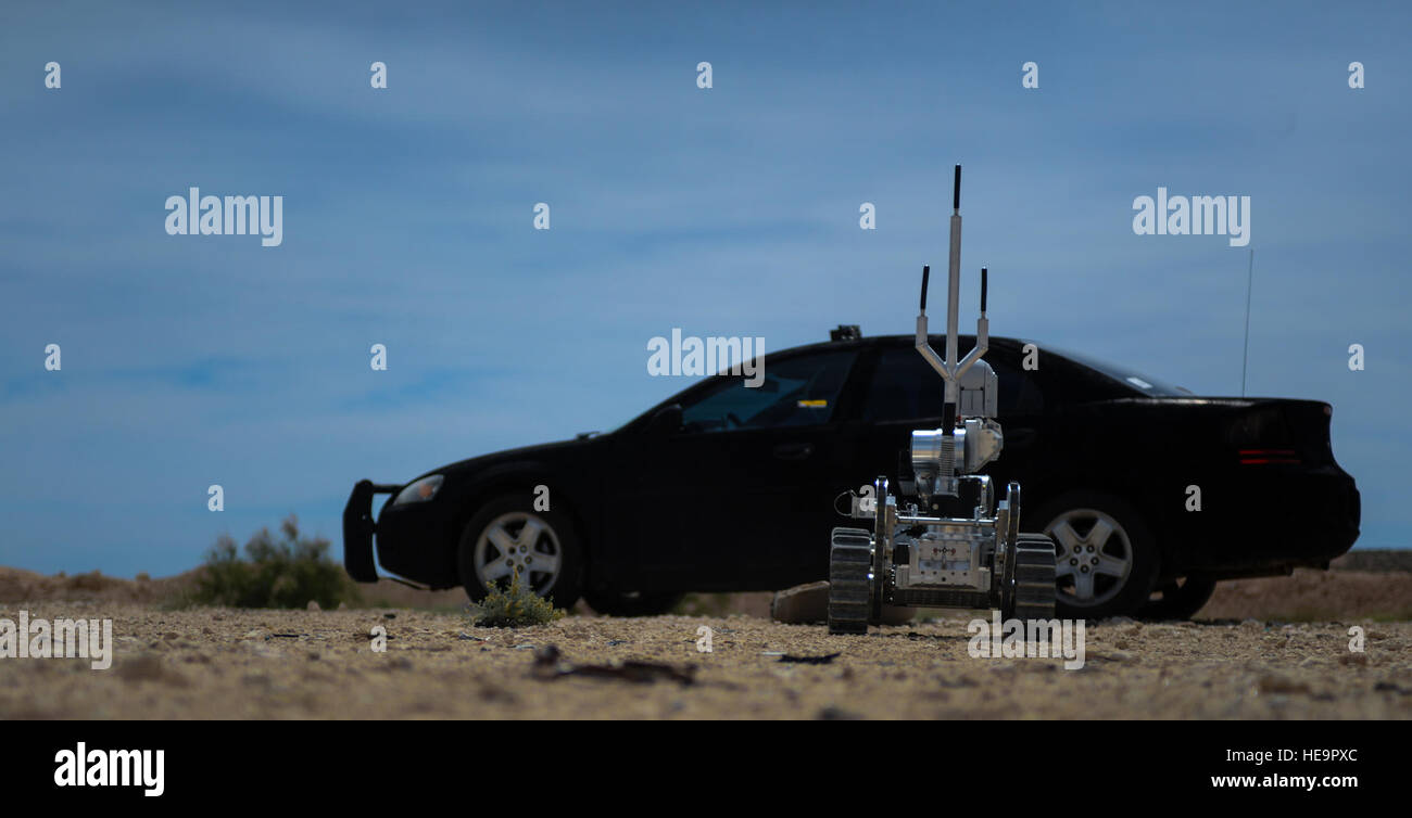 An explosive ordinance robot moves towards a car to check for a ...