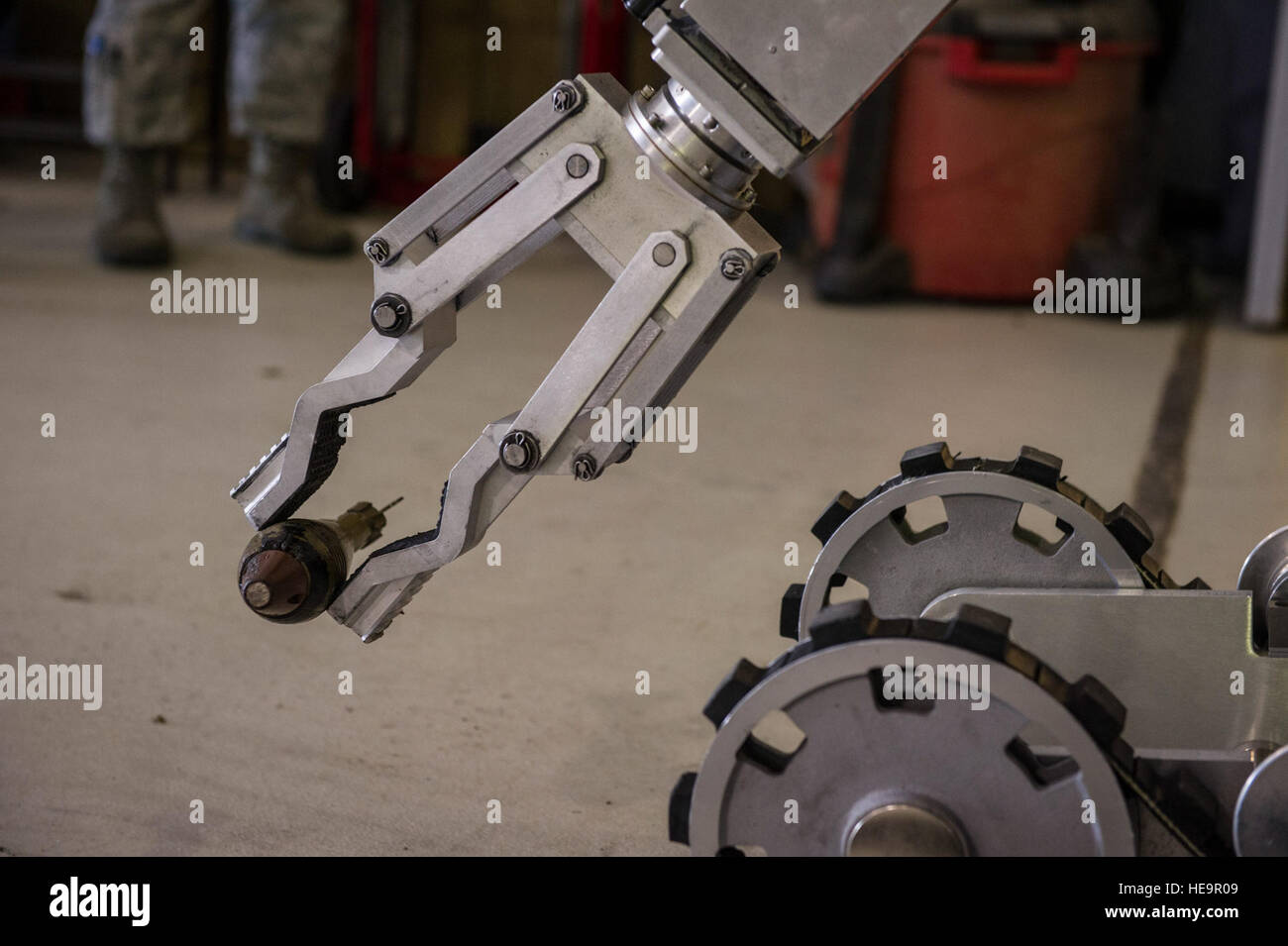 An F6 robot picks up an inert mortar during an explosive ordnance ...