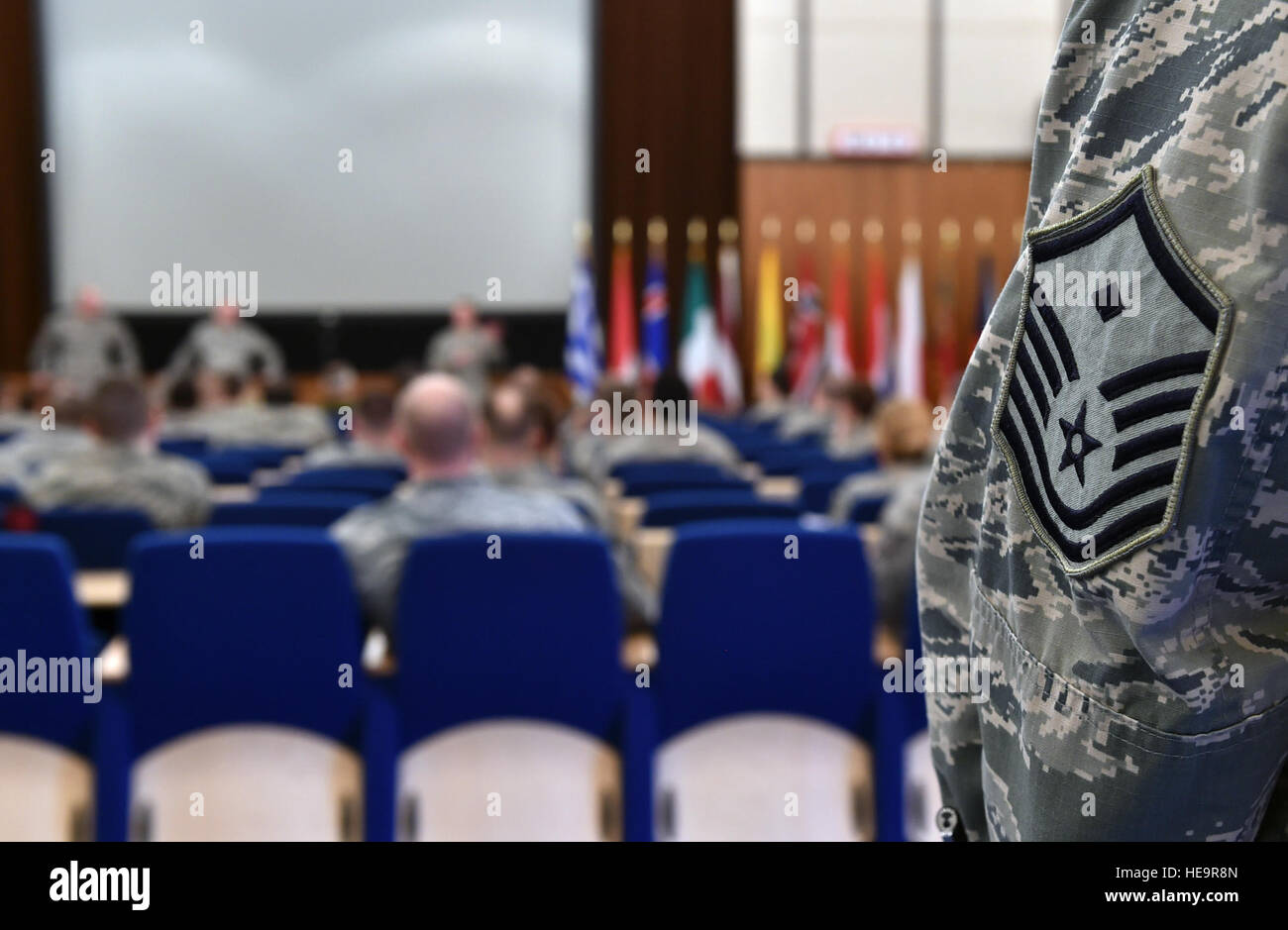 A first sergeant watches from the back of the auditorium during the ...