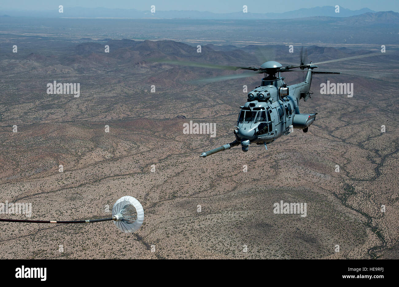 A French Air Force Eurocopter EC725 is refueled by a Lockheed HC-130J ...