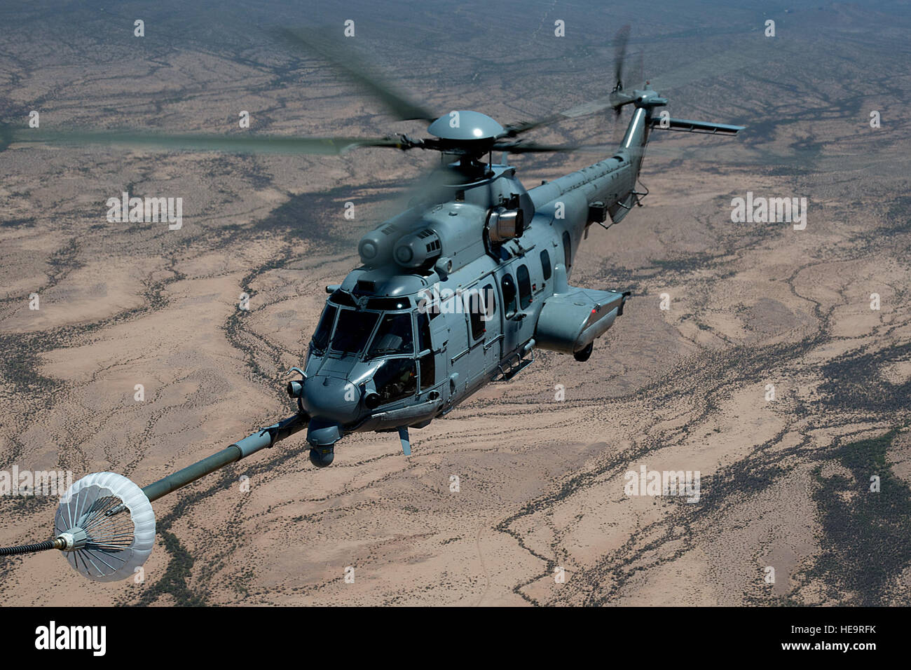 A French Air Force Eurocopter EC725 is refueled by a Lockheed HC-130J ...