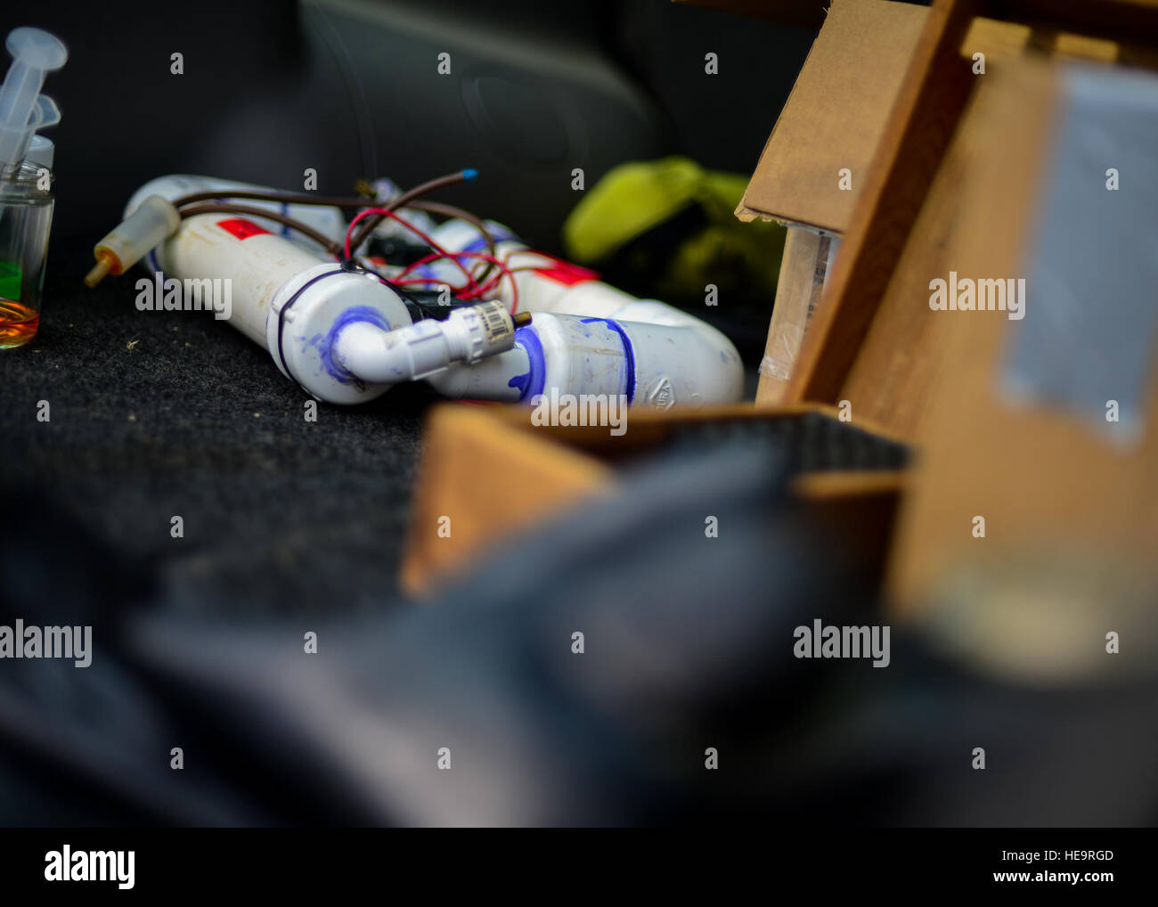 A simulated improvised explosive device sits in the back of a vehicle ...