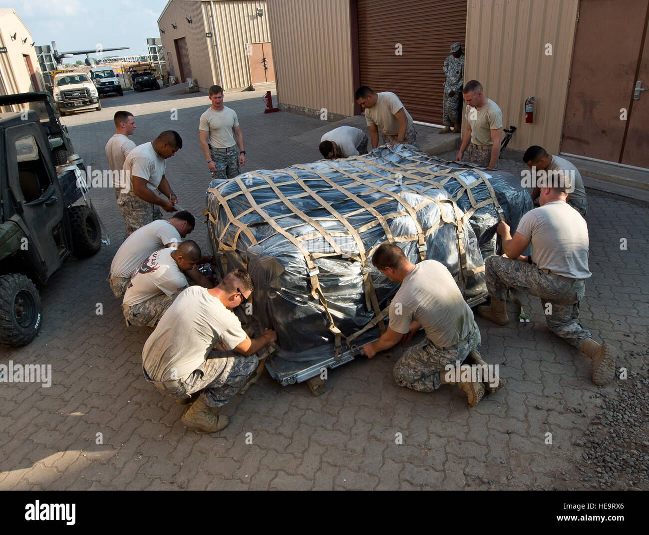 U.S. Army soldiers palletize equipment for loading onto a C-130 ...