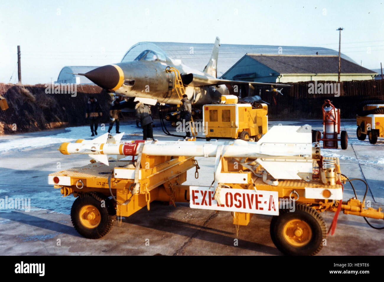 A Sidewinder is loaded onto a Republic F-105D of the 12th TFS, 18th TFW ...