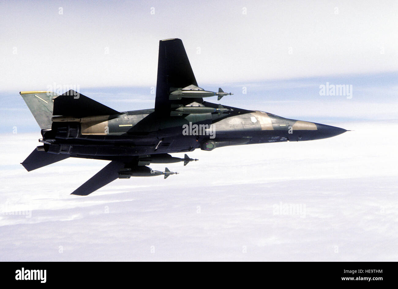 A air-to-air right side view of an F-111F aircraft, equipped with a ...