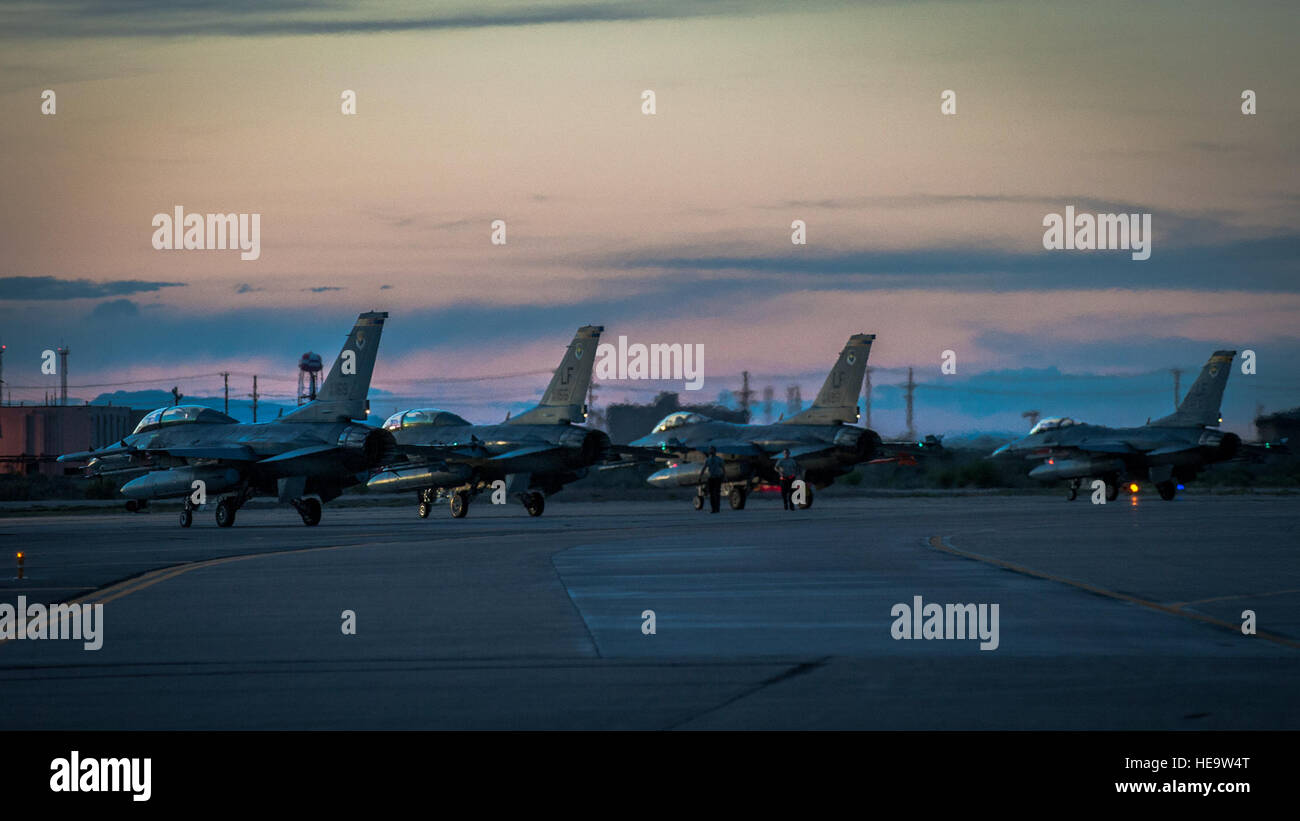 F-16 Fighting Falcons sit on the runway prior to departure at Holloman ...