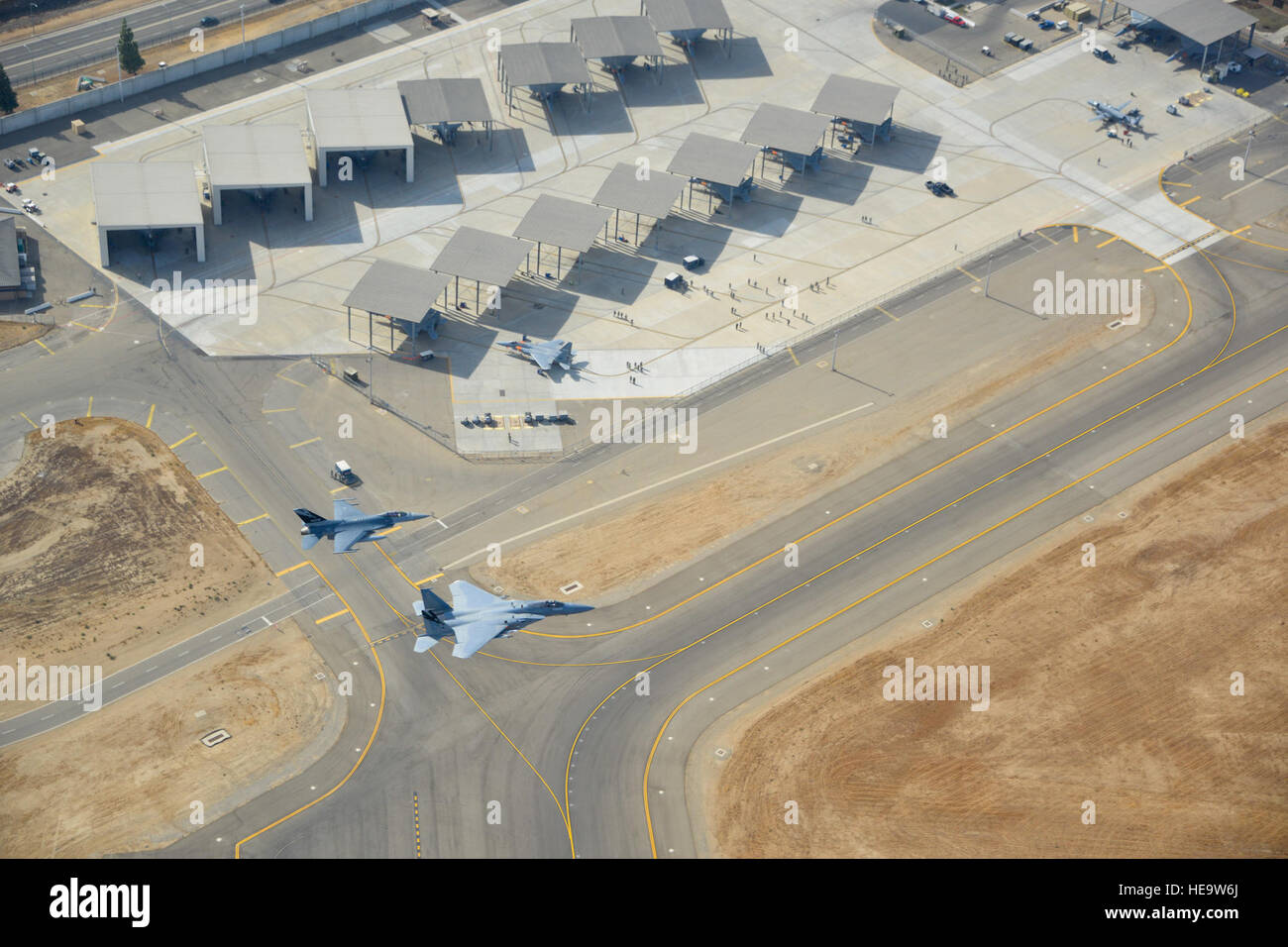 A U.S. Air Force F-15 Eagle and an F-16C Fighting Falcon fly over the ...