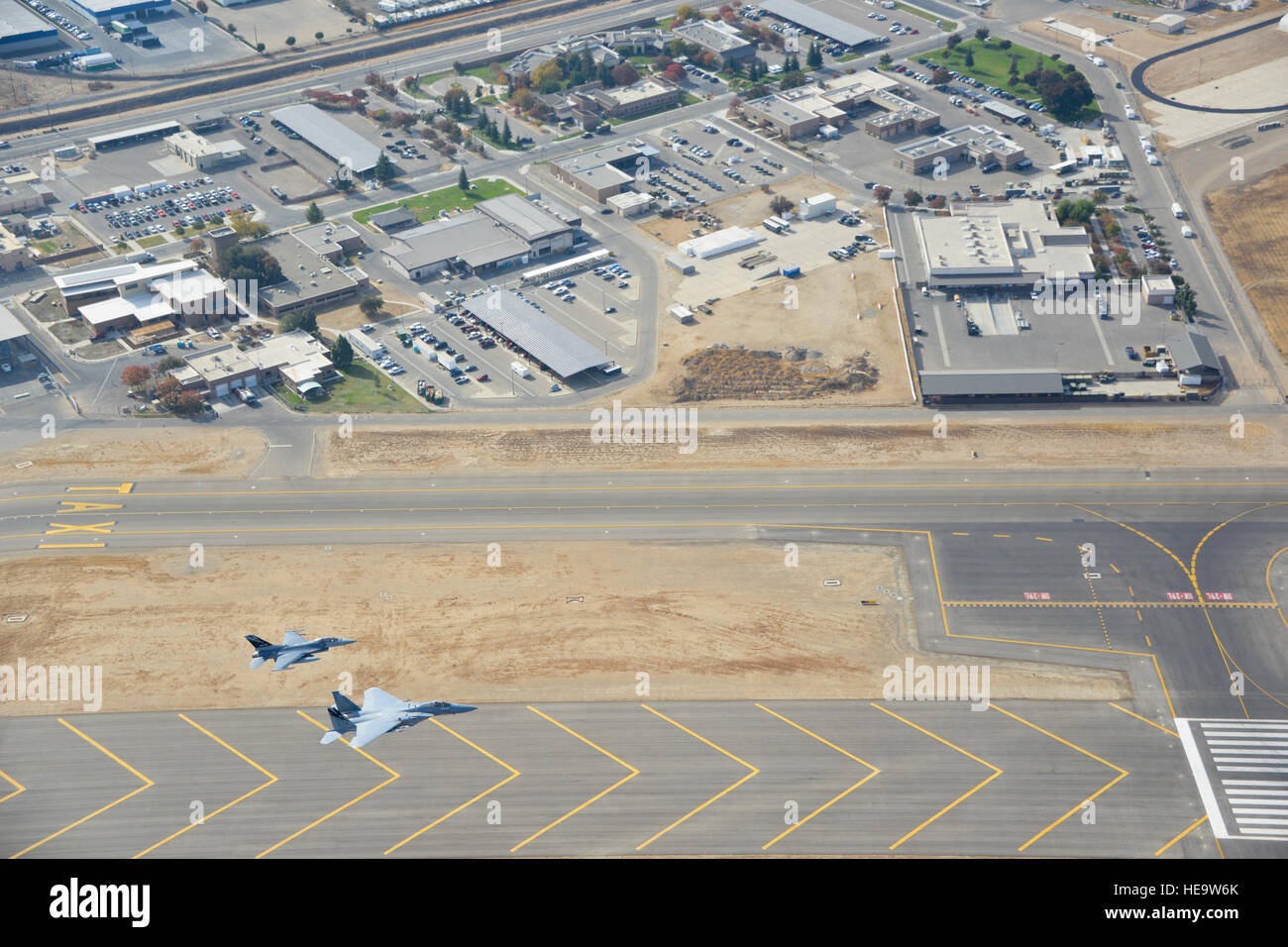 A U.S. Air Force F-15 Eagle and an F-16C Fighting Falcon fly over the ...