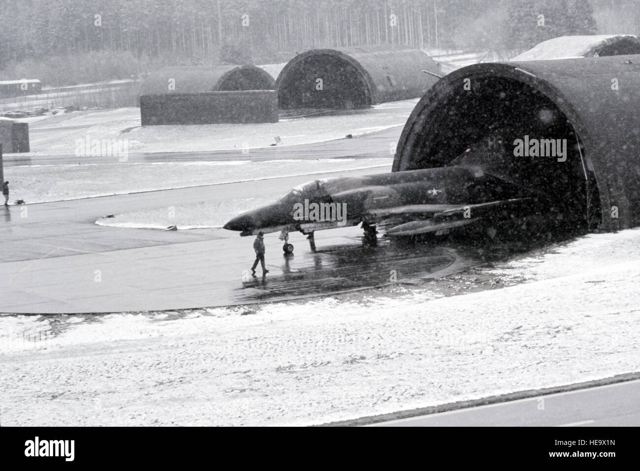 Flight line personnel wait for snowy conditions to clear prior to ...