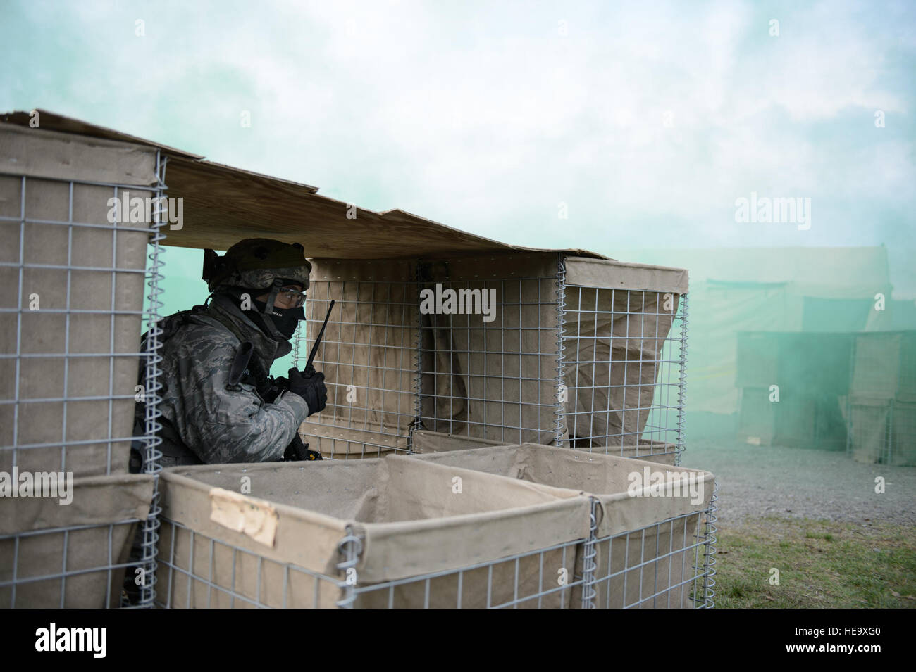 A 1st Combat Communications Squadron Airman makes a call on a radio as ...
