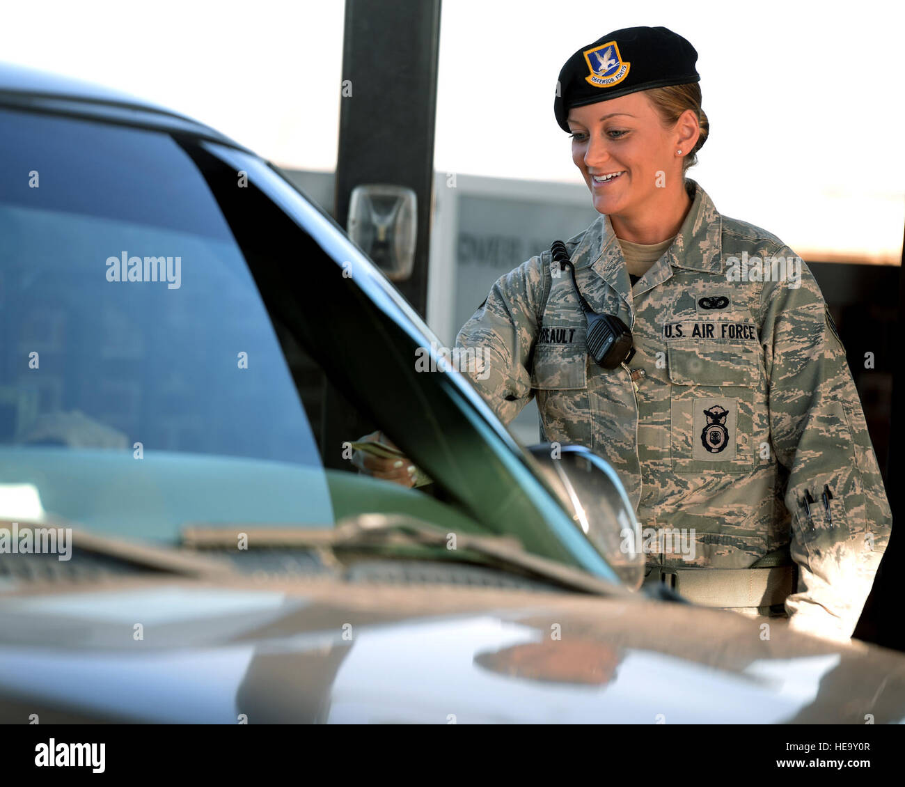 Air Force Security Forces personnel check identification at the front ...
