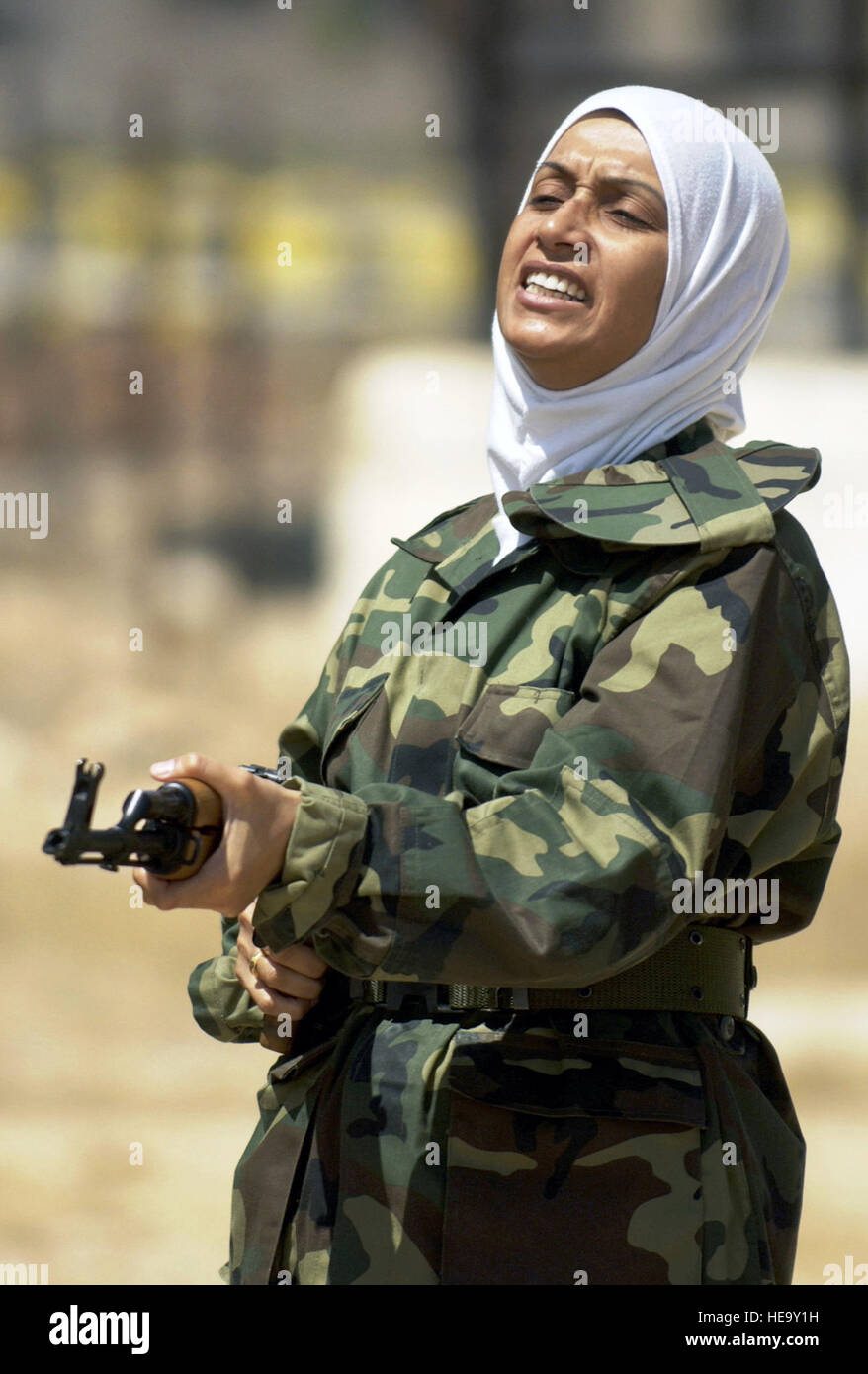 Afrah, an Iraqi Army basic trainee, yells "clear" to let trainers know ...