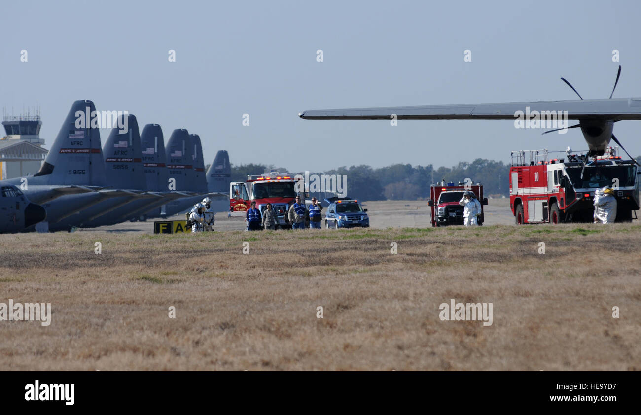 Wing inspection team members assess the area as Keesler firefighters ...