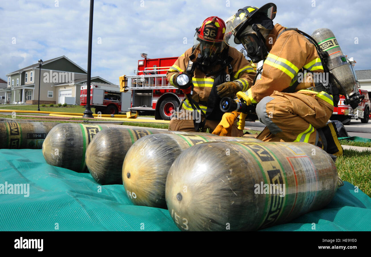 Firefighters from the 509th Civil Engineer Squadron set up oxygen tanks ...