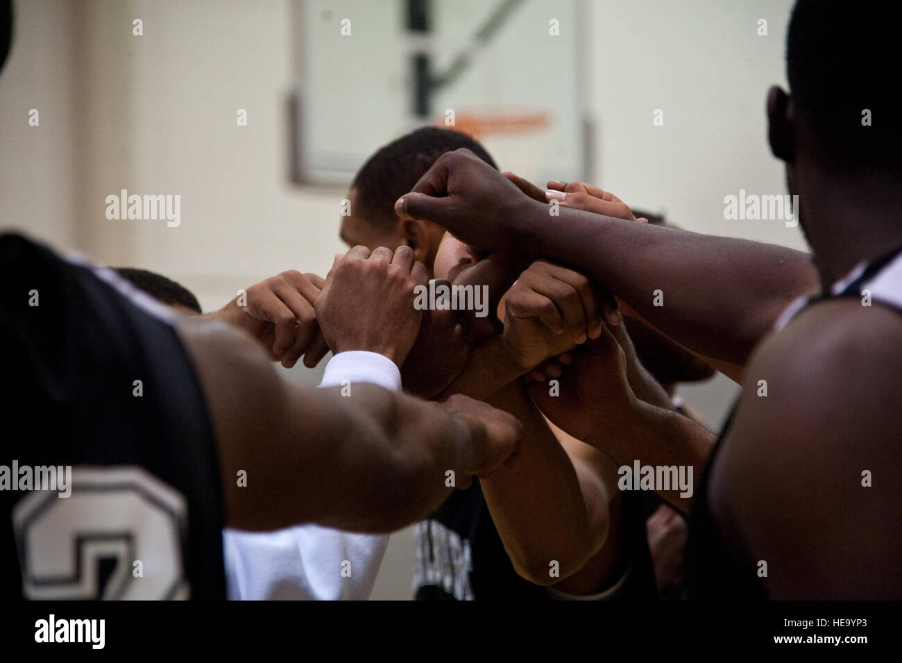 The Hurlburt Field Commandos basketball team, huddle during a time-out ...