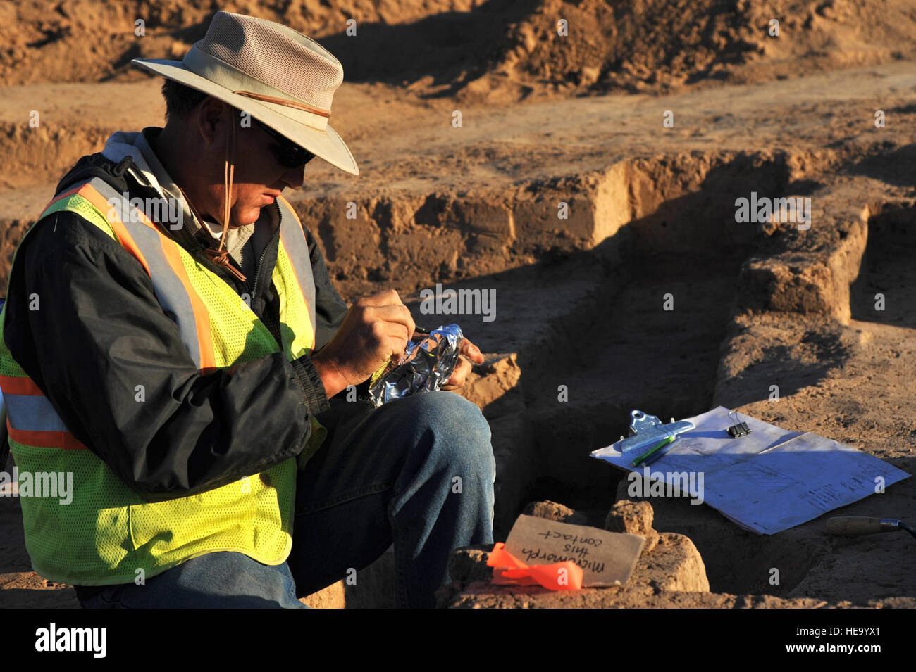 Dr. Jeff Homburg, archaeologist field technician, performs ...