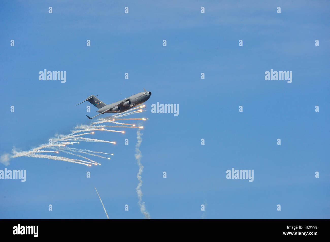A Dover C-17A Globemaster III expends countermeasure flares to defeat a ...