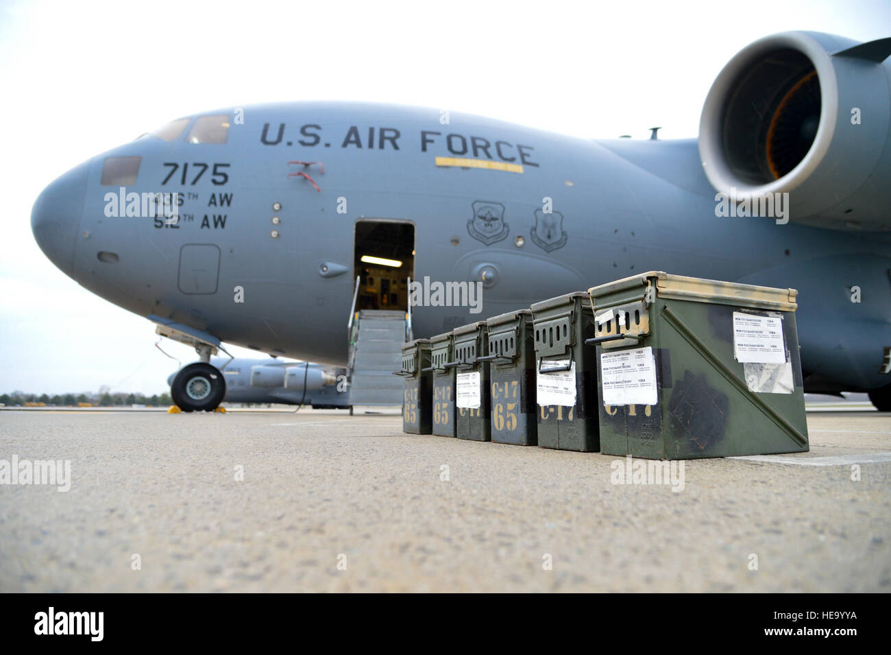 A flare set sits on the flight line next to a C-17A Globemaster III ...