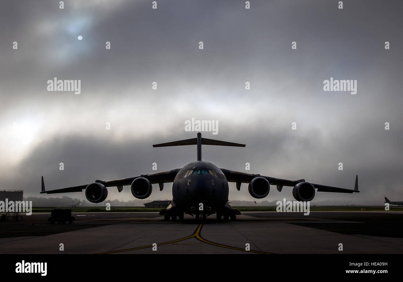 A C-17 Globemaster III sits on the fog-covered flightline at Joint Base ...