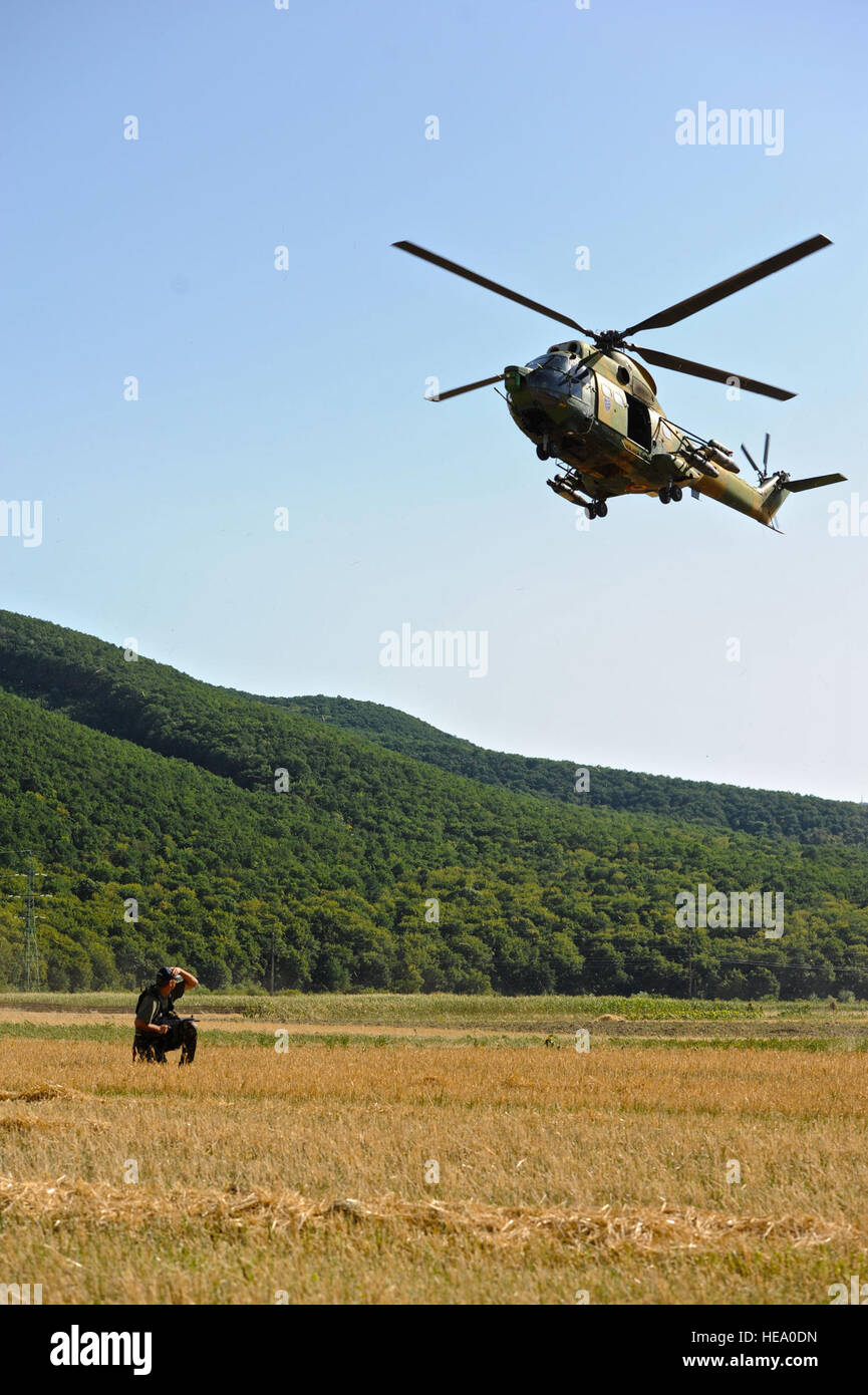 A Romanian air force IAR 330 helicopter prepares to land after a ...