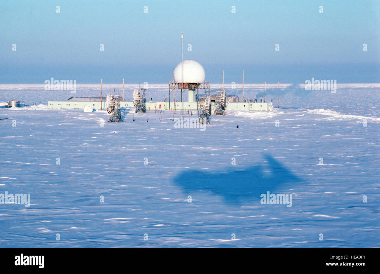 The shadow of an aircraft passes over a radar station. The radar ...
