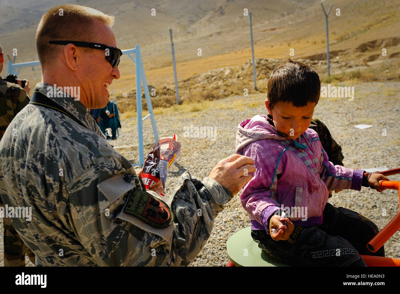 U.S. Air Force Master Sgt. Steve Horton, ISAF Joint Command, hands out ...