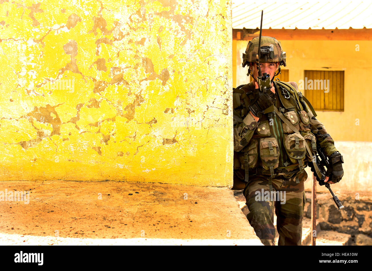 A French marine, 5th Marine Regiment, directs his squad via radio ...