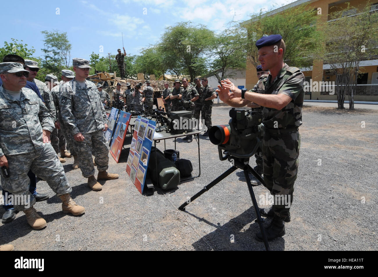 A French infantryman displays a rocket launcher to American military ...