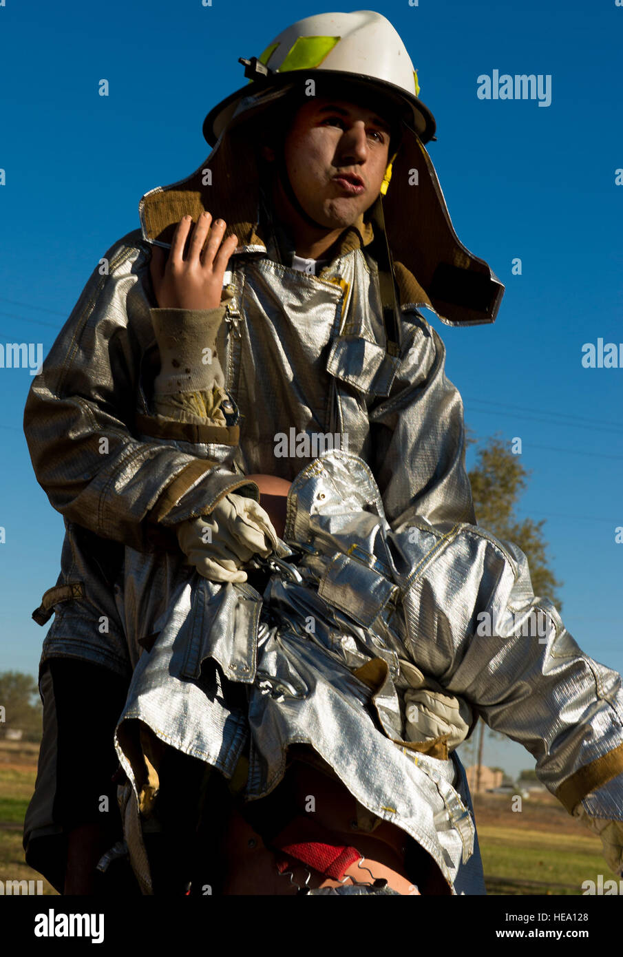 An Air commando struggles to carry a medical dummy clothed in fire ...
