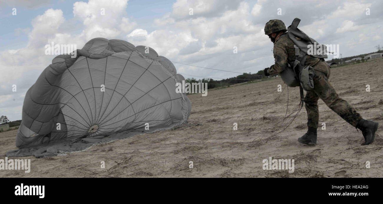 A German paratrooper lands on a drop after exiting an aircraft at Night ...