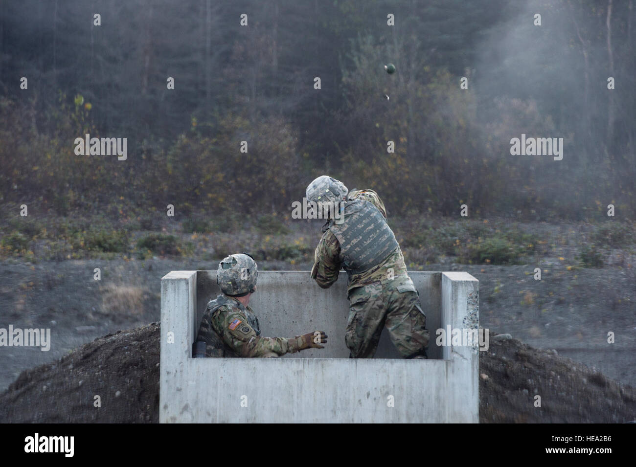 U.S. Army Spc. Stephen Maklos, right, throws a M67 fragmentation ...
