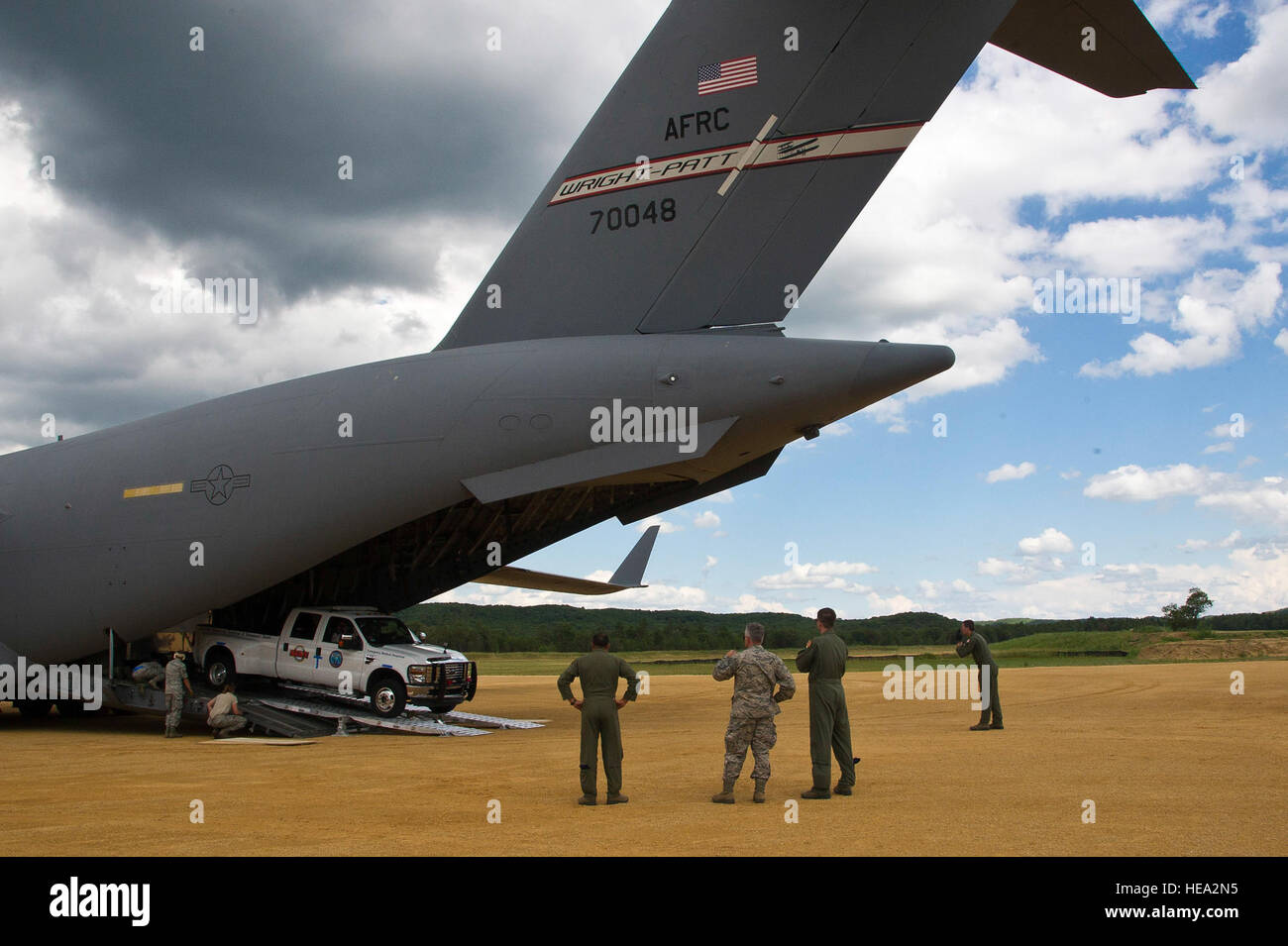 U.S. Air Force airmen help unload equipment belonging to the Advanced ...