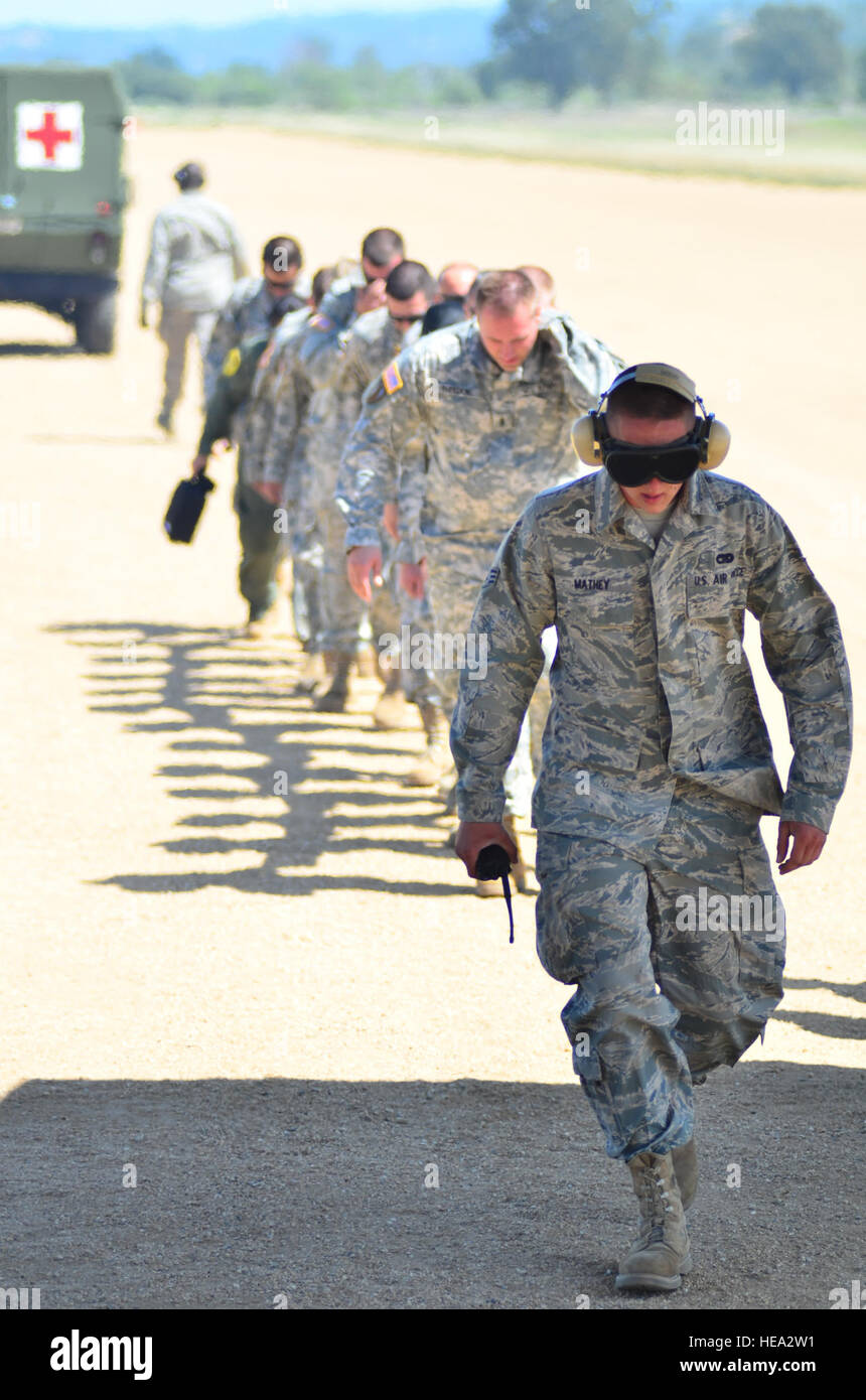 U.S. Air Force Senior Airman Bryan Mathey, 42nd Aerial Port Squadron, Westover, Mass., guides ...