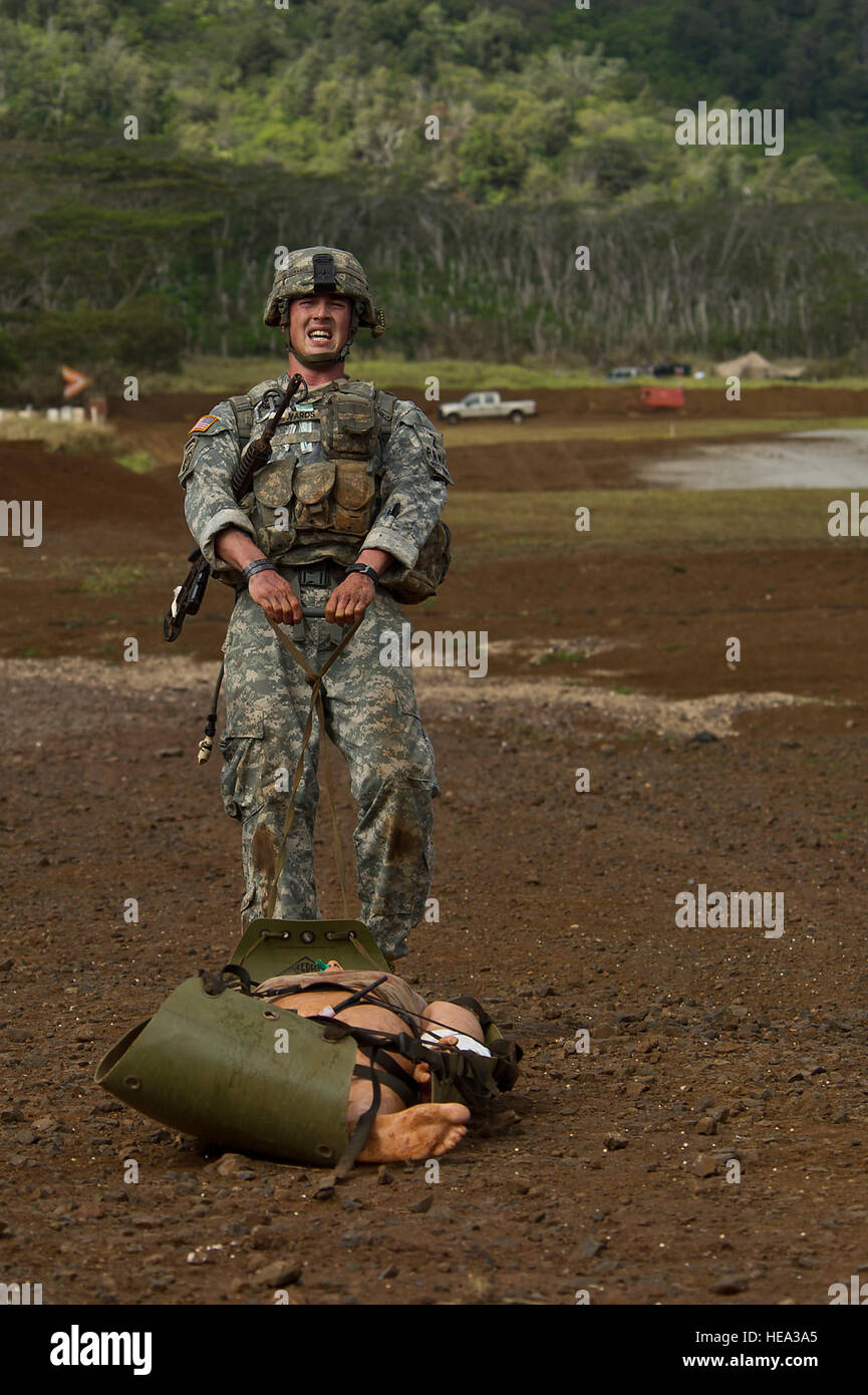 A U.S. Army combat medic uses a Sked to move a simulated casualty to ...