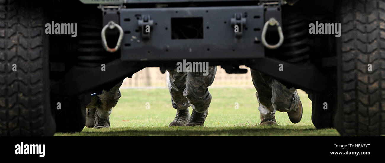 Airmen from the 97th Security Forces Squadron push a Humvee during the ...