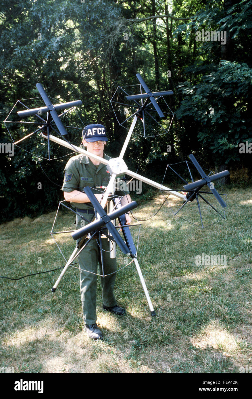 A member of the Air Force Communications Command positions an antenna ...