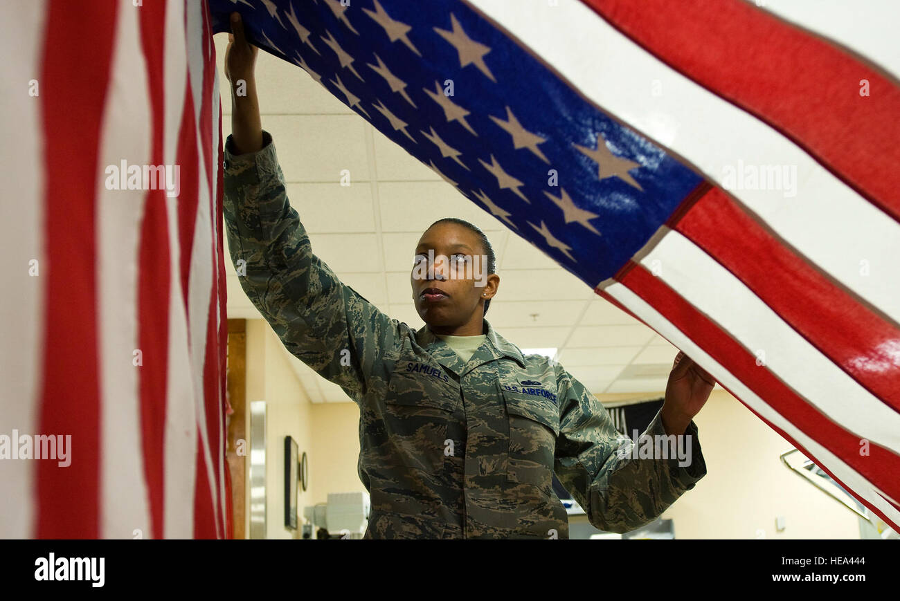 Staff Sgt. Star Samuels hangs up a U.S. flag used to accompany remains ...