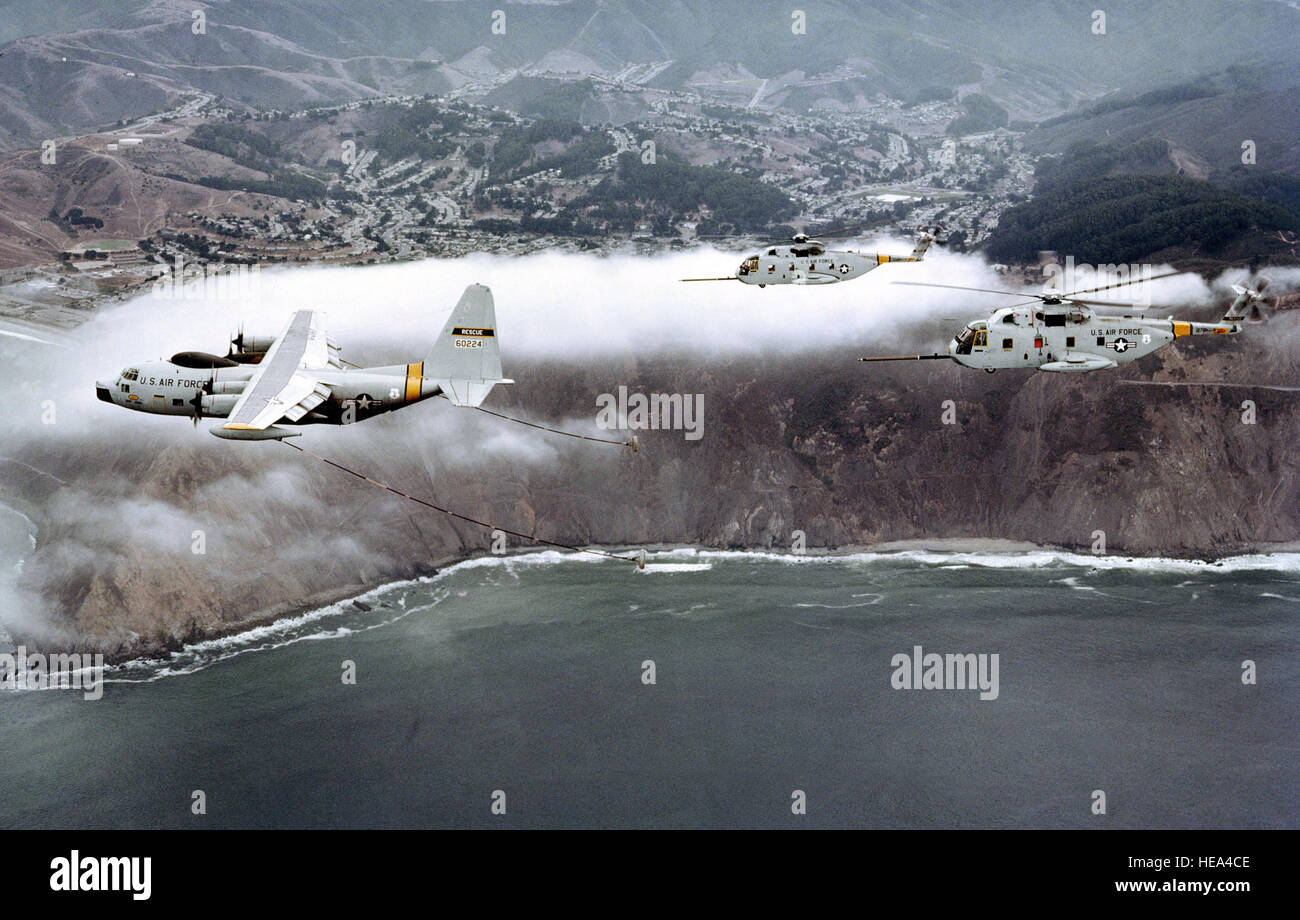 An air-to-air left side view of an HC-130 Hercules aircraft maneuvering ...