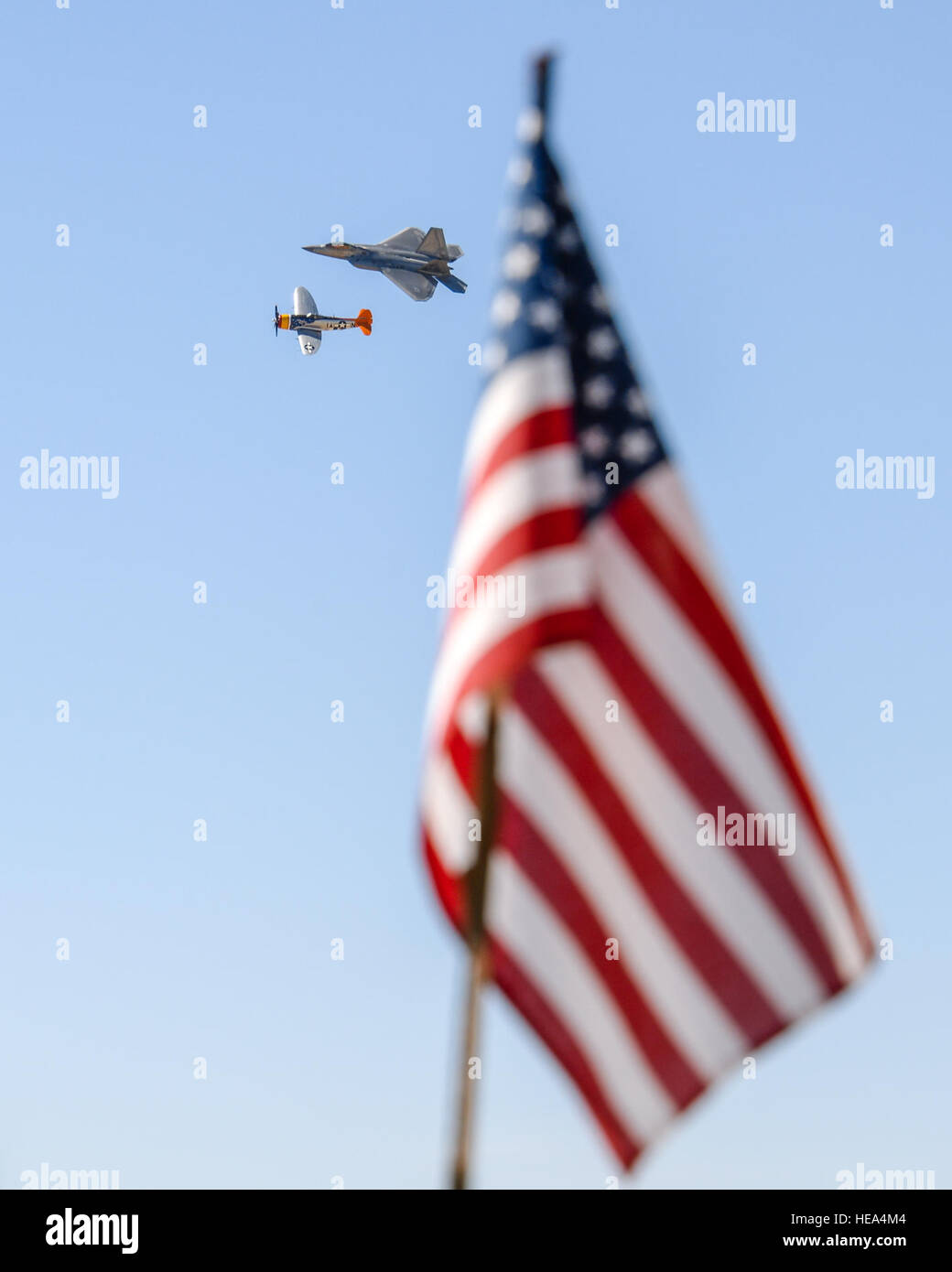 An F-22 Raptor and P-51 Mustang fly in formation during the 2016 ...